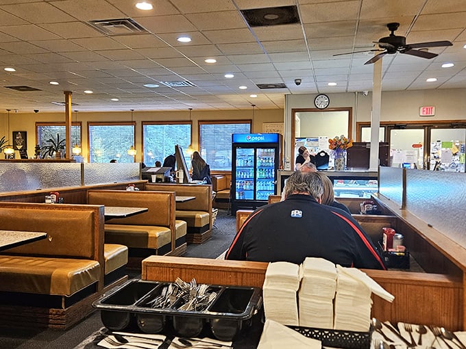 The dining area hums with conversation and silverware symphonies. Every booth tells a story, and most involve someone saying, "I couldn't eat another bite" before ordering pie.