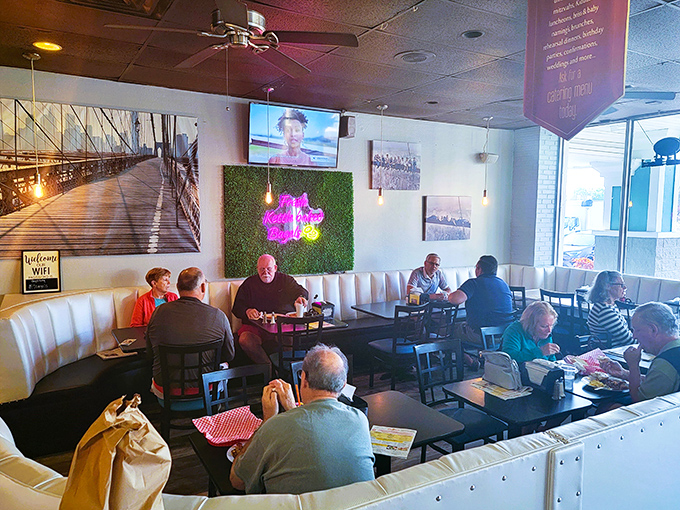 The dining area balances deli authenticity with Florida comfort&mdash;note the Brooklyn Bridge mural nodding to bagel heritage.
