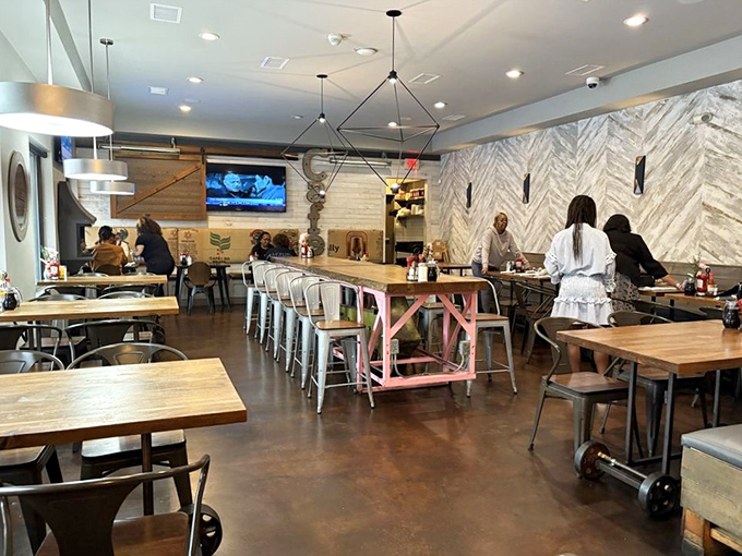 A dining room where rustic charm meets modern sensibility. Those geometric light fixtures are having a serious conversation with that wooden communal table.