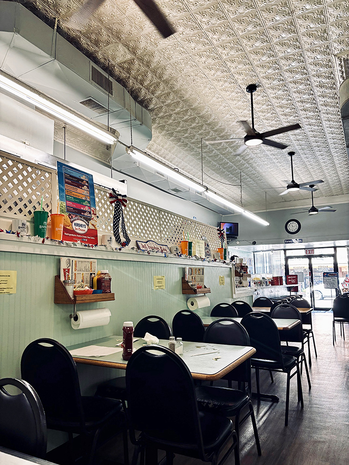 Classic American diner poetry &ndash; pressed tin ceiling, ceiling fans spinning stories, and tables waiting for your elbows and conversations.