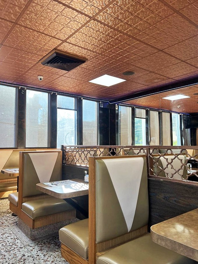 Classic booth seating where conversations flow as smoothly as the endless coffee refills.