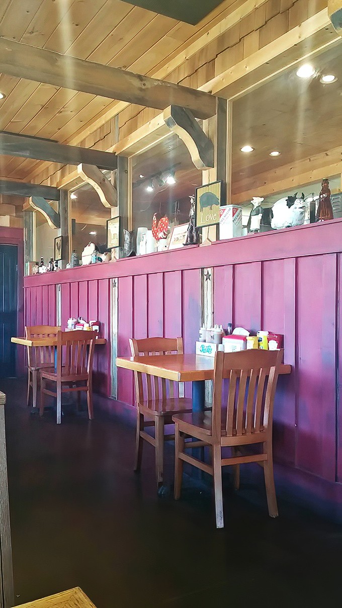 The dining area's burgundy wainscoting and wooden beams create an atmosphere that says, "Stay awhile, there's pie coming later."