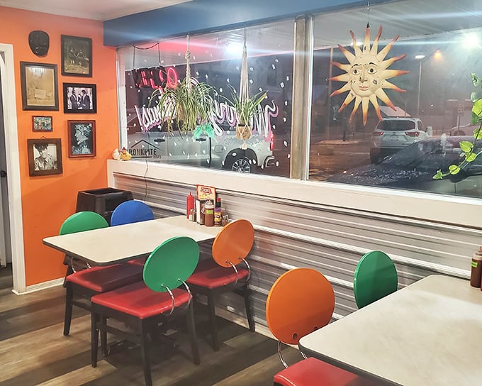 Colorful chairs pop against orange walls while a watchful sun decoration keeps an eye on diners. It's like eating inside a children's book illustrated by someone who really understands comfort.