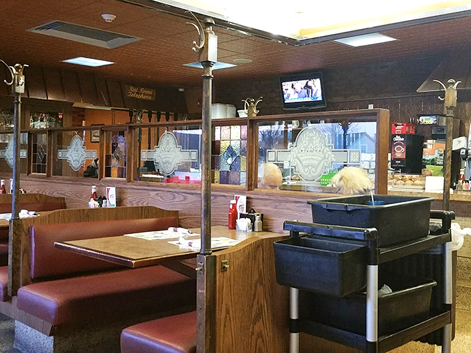 Wood paneling and burgundy booths create that timeless diner atmosphere where you half-expect to see the Fonz walk in.