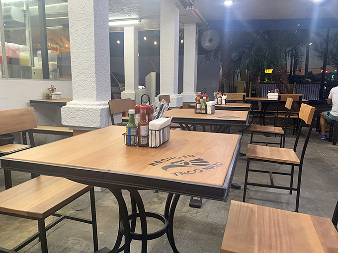 The Taco Nazo logo proudly displayed on wooden tabletops – like sitting at the dining room table of an old friend who happens to make incredible tacos.