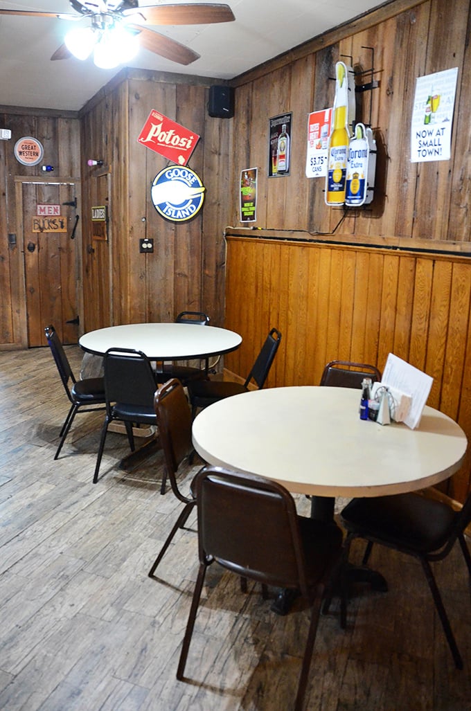 Wood-paneled walls and simple tables create that authentic small-town tavern vibe that no corporate restaurant chain can successfully replicate.