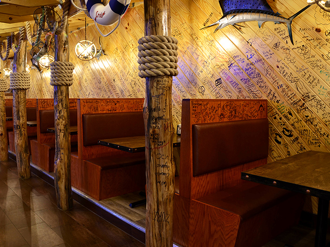 Wooden booths adorned with nautical rope and walls covered in visitors' signatures&mdash;each table a private dock for your seafood adventure.