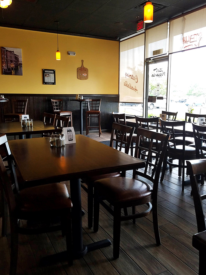 Empty tables waiting for hungry diners. Like a blank canvas before a masterpiece, soon to be filled with laughter and pizza-induced happiness.