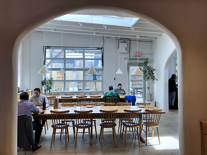 Archways frame the dining experience like a Renaissance painting. Light floods in, setting the stage for pizza euphoria.