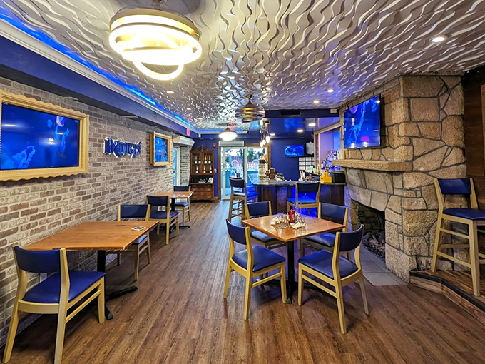 Blue lighting transforms this dining area into an underwater fantasy where wooden tables anchor you to reality while flavors set you adrift.