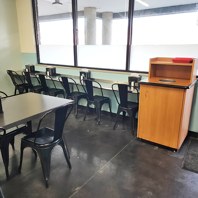 Simple metal chairs and clean tables say, "We put our energy into the food, not the furniture." Smart priorities.