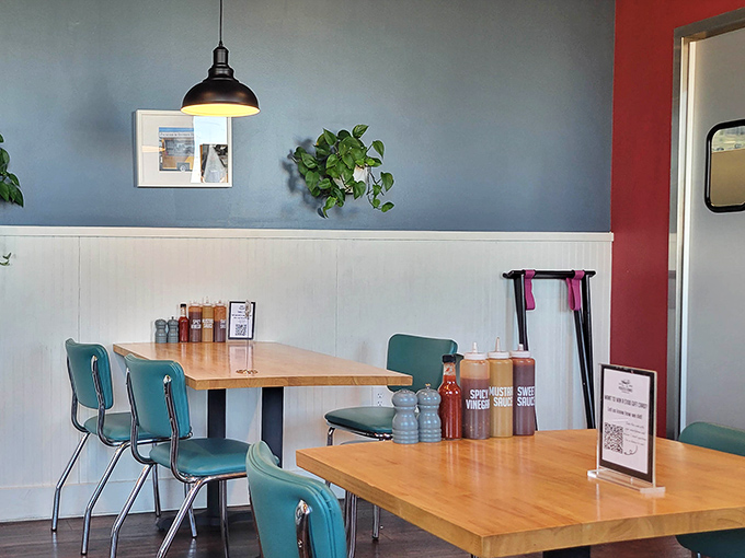 Simple elegance with those pendant lights and blue-green color scheme. The sauce bottles stand ready, like little soldiers awaiting their call to duty.
