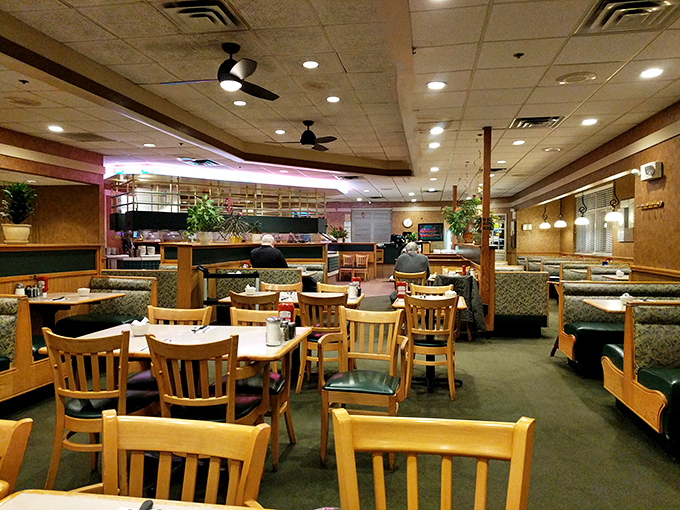 The dining room's wood tones and booth seating create that perfect diner atmosphere where breakfast at 8 PM feels completely reasonable.