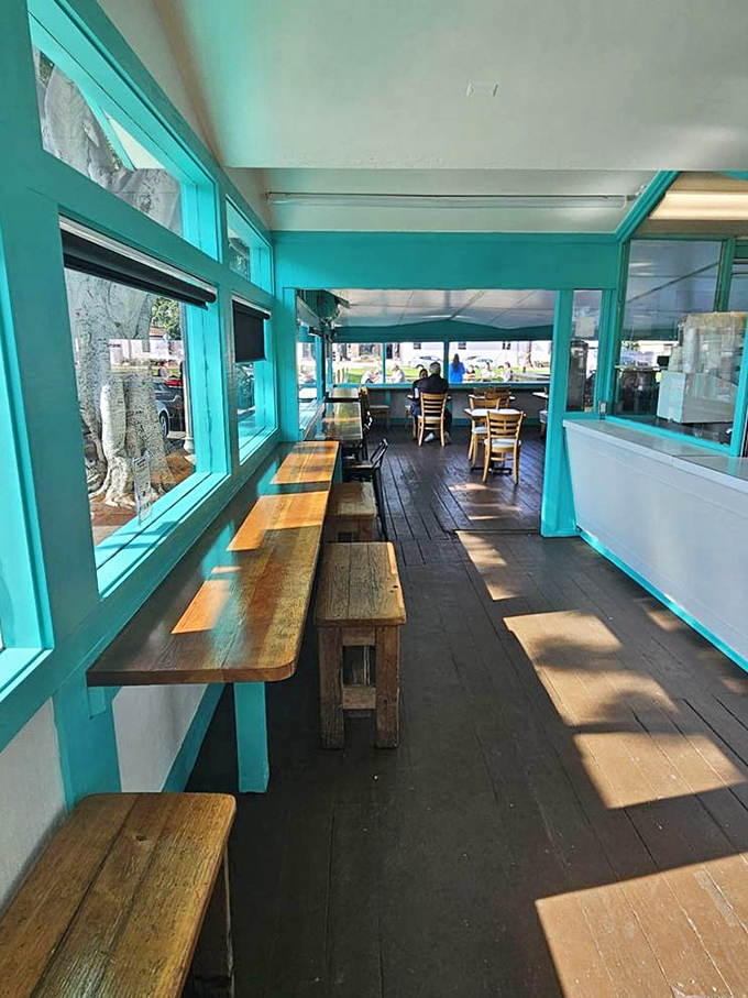 Rustic wooden benches line the sun-dappled dining area. This is where strangers become friends over shared tamale revelations.