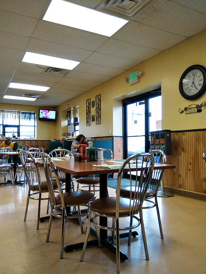 Simple tables, comfortable chairs, and yellow walls &ndash; the dining area has everything you need and nothing you don't.