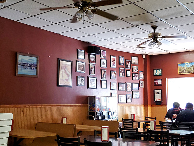 The dining room wall gallery&mdash;a visual history of Pittsburgh and proud pizza moments. Every frame tells a story; every booth holds memories.