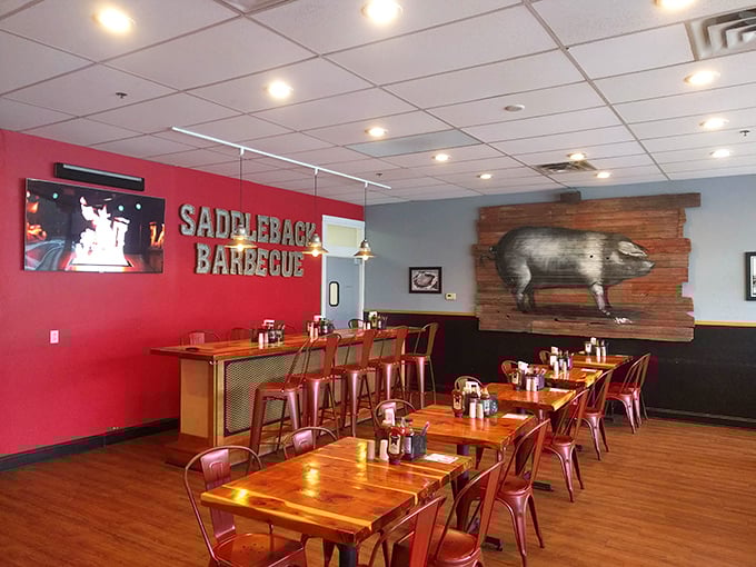 The dining room's red accent wall and pig artwork announce without subtlety: "Serious meat business happens here," while still maintaining that crucial "everyone's welcome" atmosphere.