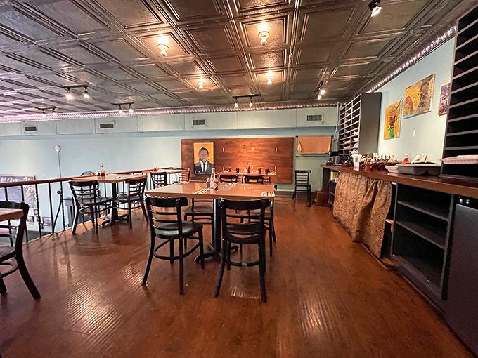 The second-floor dining area offers a bird's-eye view of the breakfast drama unfolding below. Tin ceilings reflect the warm glow of pendant lights.