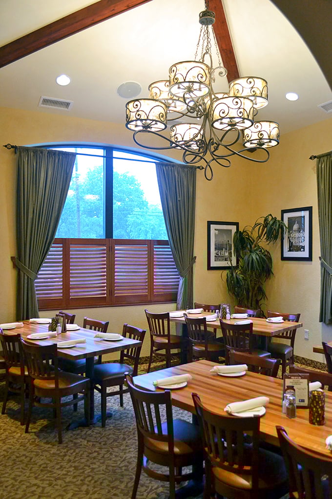 Elegant chandeliers cast a warm glow over wooden tables, creating the perfect setting for the age-old tradition of twirling pasta and making memories.