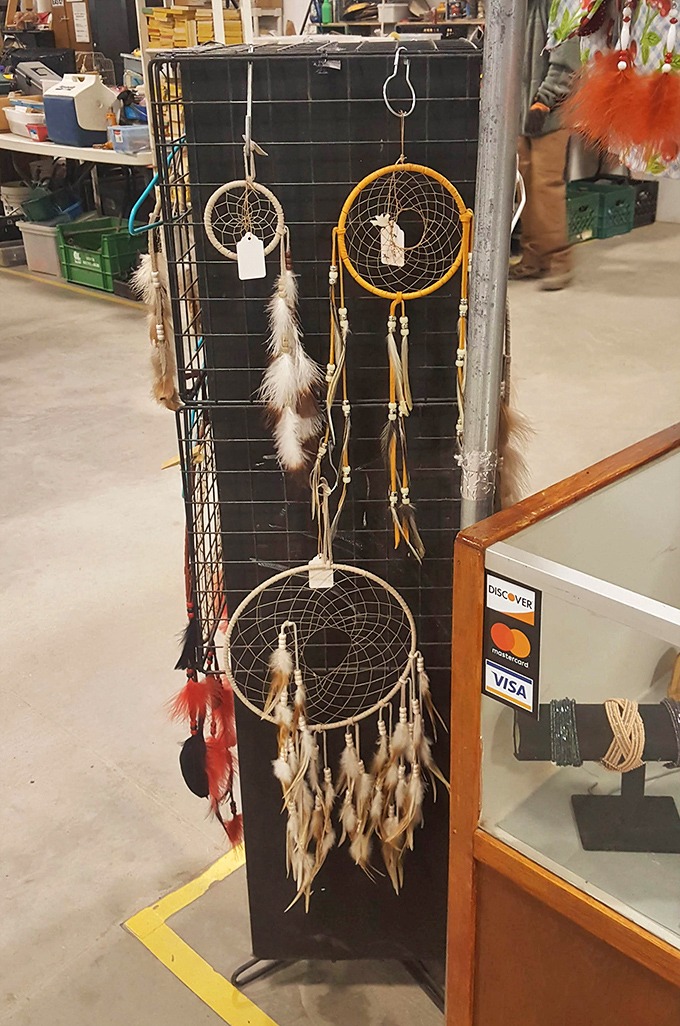Dreamcatchers sway gently in the indoor breeze, their feathers promising to filter nightmares while their price tags won't cause any.