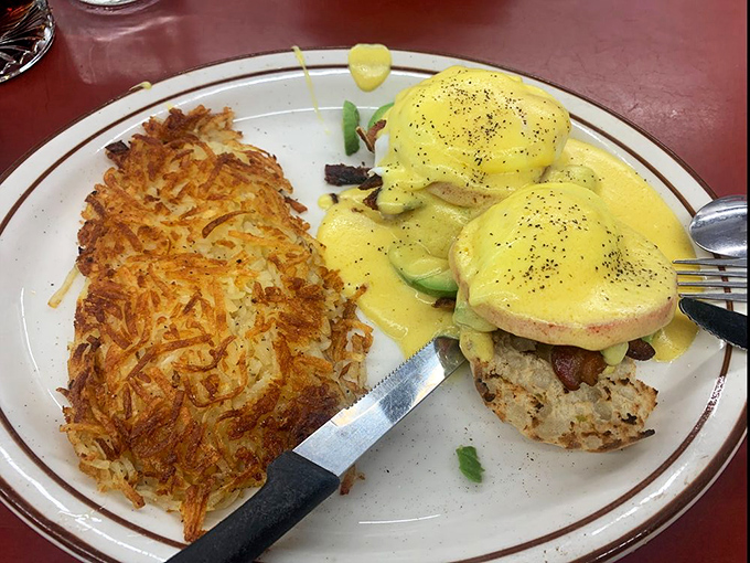 Benedict perfection: golden hollandaise cascading over poached eggs, with hash browns so crispy they practically shatter when your fork hits them.
