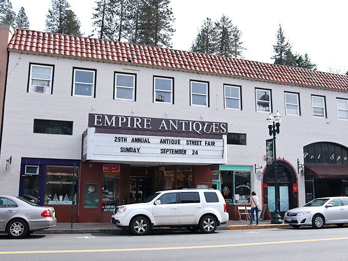 Empire Antiques advertises its street fair, embodying Placerville's community spirit where neighbors still gather for events that don't require second mortgages to enjoy.
