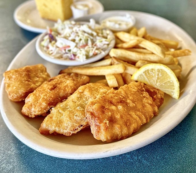 Fish and chips golden enough to make King Midas jealous, with a crunch you can practically hear through the photo.