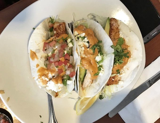 Fish tacos that bring coastal vacation vibes to your Greenville lunch break. The garnishes add both color and zesty personality.