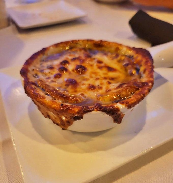 French onion soup with a cheese pull that deserves its own standing ovation &ndash; bubbling, golden, and gloriously excessive.