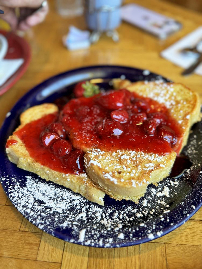 French toast that's living its best life under a blanket of strawberry compote&mdash;the breakfast equivalent of wearing pajamas to a five-star hotel.