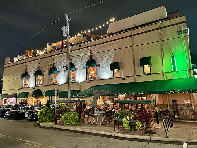 The Great American Pub glows with invitation after dark, its string lights promising cold drinks and warm conversations inside.