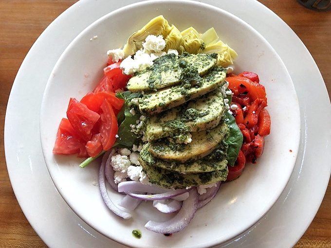 A Mediterranean-inspired salad that proves healthy eating doesn't mean punishment. Vibrant tomatoes and pesto-dressed chicken create a colorful canvas.