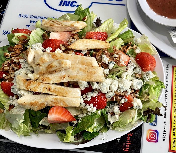 Even salads get the royal treatment here&mdash;strawberries, grilled chicken, and blue cheese proving healthy doesn't mean boring.