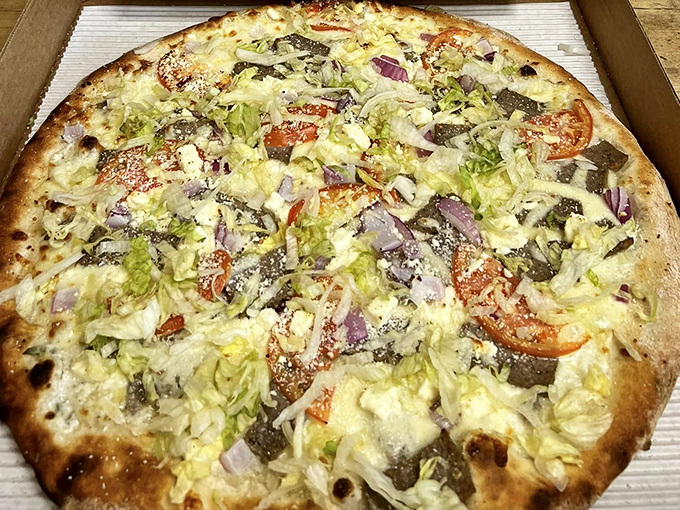 The veggie-loaded pizza proves that eating your greens can be indulgent when they're nestled on perfect dough.