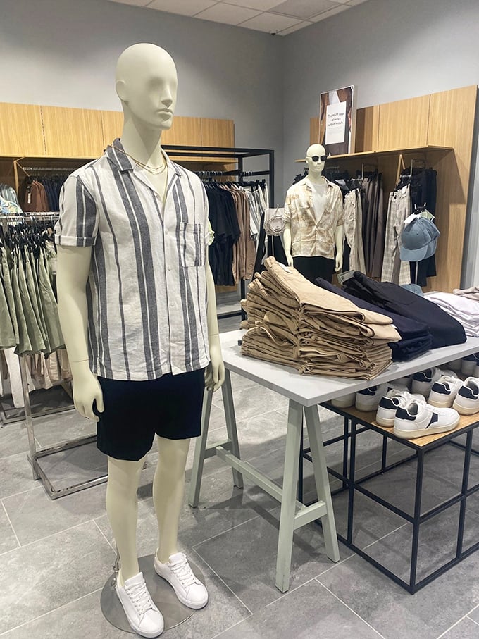 Mannequins sporting summer-ready attire stand in silent judgment of your winter body, while offering hope in the form of breezy linen shirts.