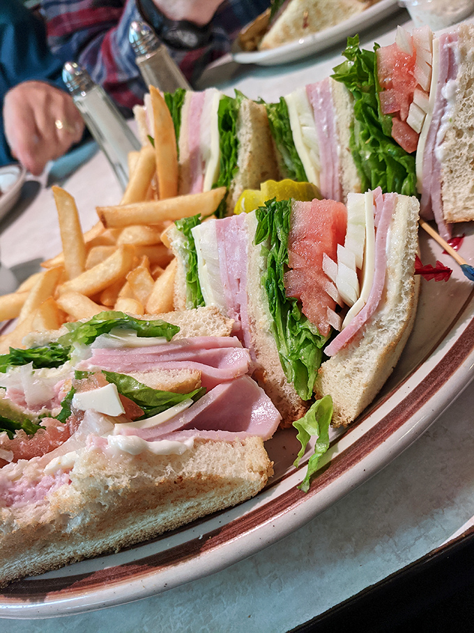 Club sandwiches: the skyscrapers of the sandwich world. Each layer tells its own story of freshness, with crisp lettuce providing the necessary crunch factor.