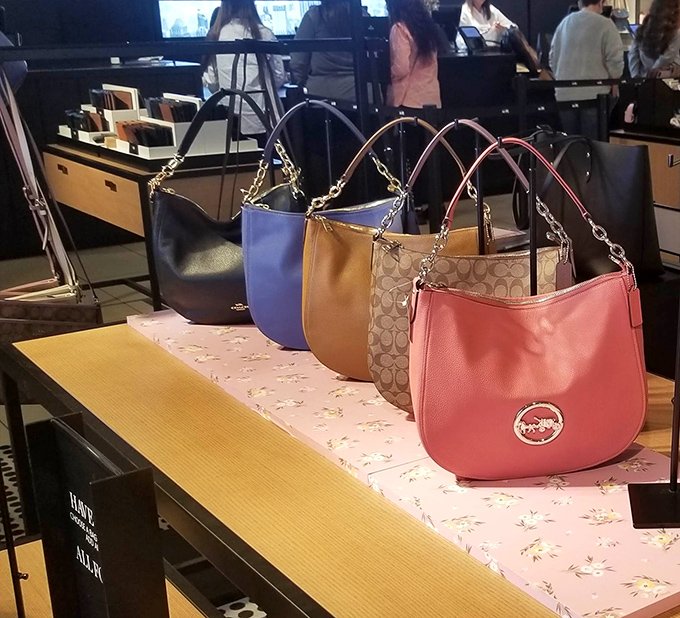 Handbag heaven where each purse silently promises to be the one that finally organizes your life (results may vary).