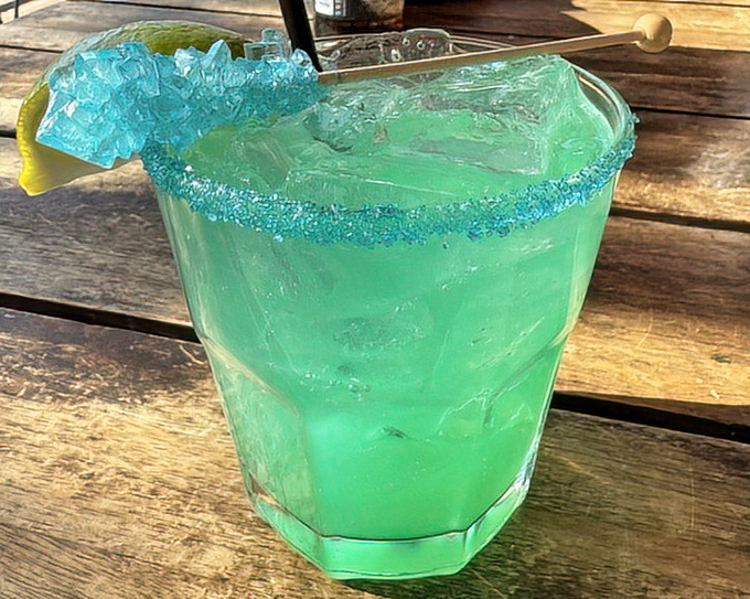 This electric blue concoction isn't just a drink &ndash; it's vacation in a glass, complete with sugar rim and enough ice to sink a tiny paper umbrella.