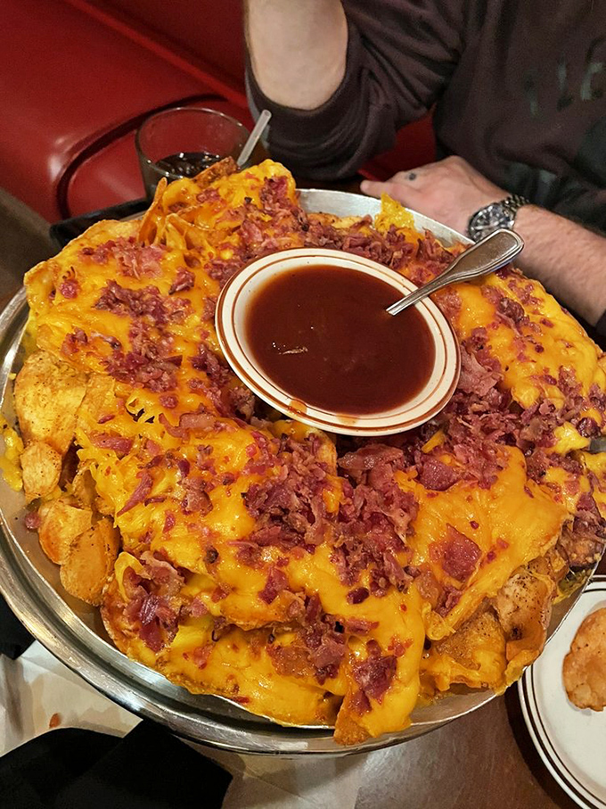 Loaded nachos that require a strategic eating plan. The center cup of sauce is like the treasure at the end of a deliciously cheesy rainbow.