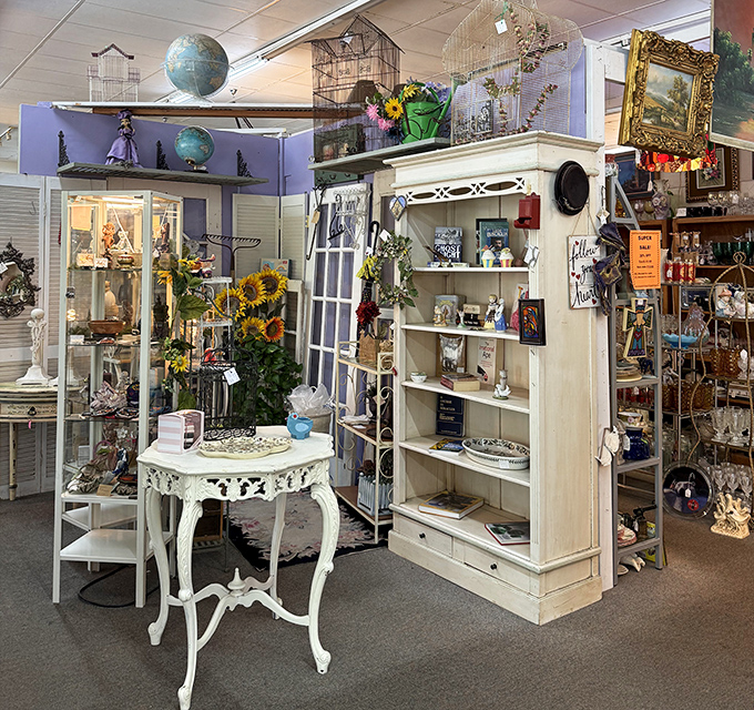 White furniture that somehow survived decades without encountering red wine or children. The bird cage and globe suggest worldliness; the sunflowers promise joy.