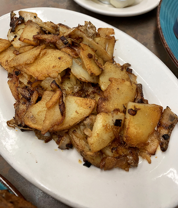 Home fries done right are never an afterthought. These golden-brown beauties have been introduced to just the right amount of onion and seasoning.