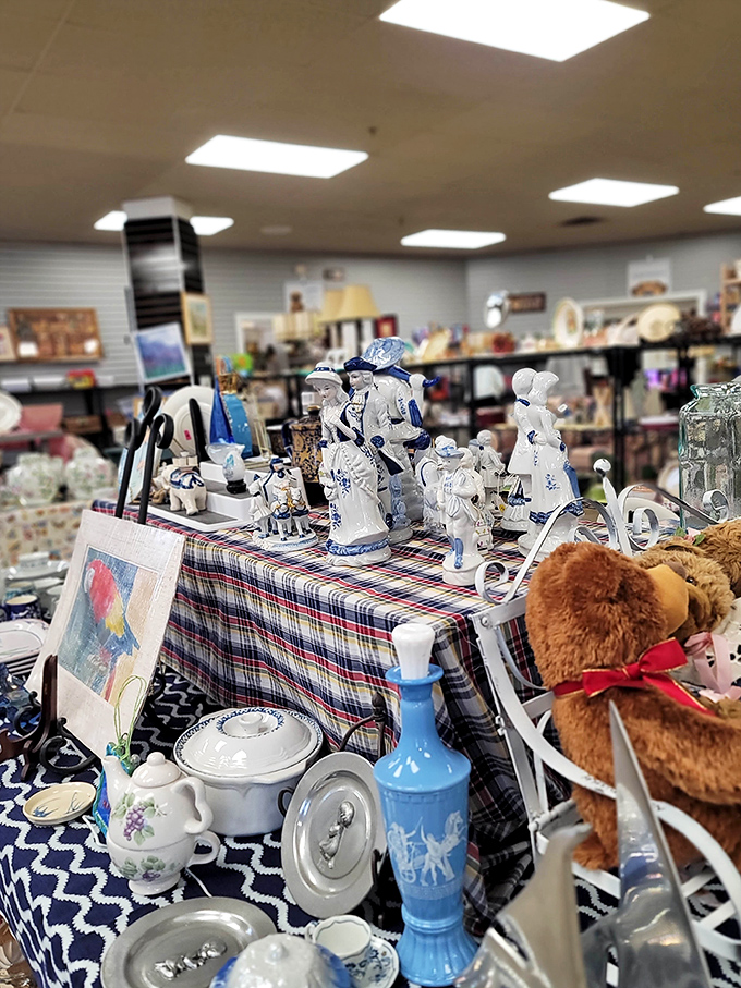 Delicate porcelain figurines and vintage blue glassware await collectors with discerning eyes, each piece holding memories of dinner parties and special occasions past.