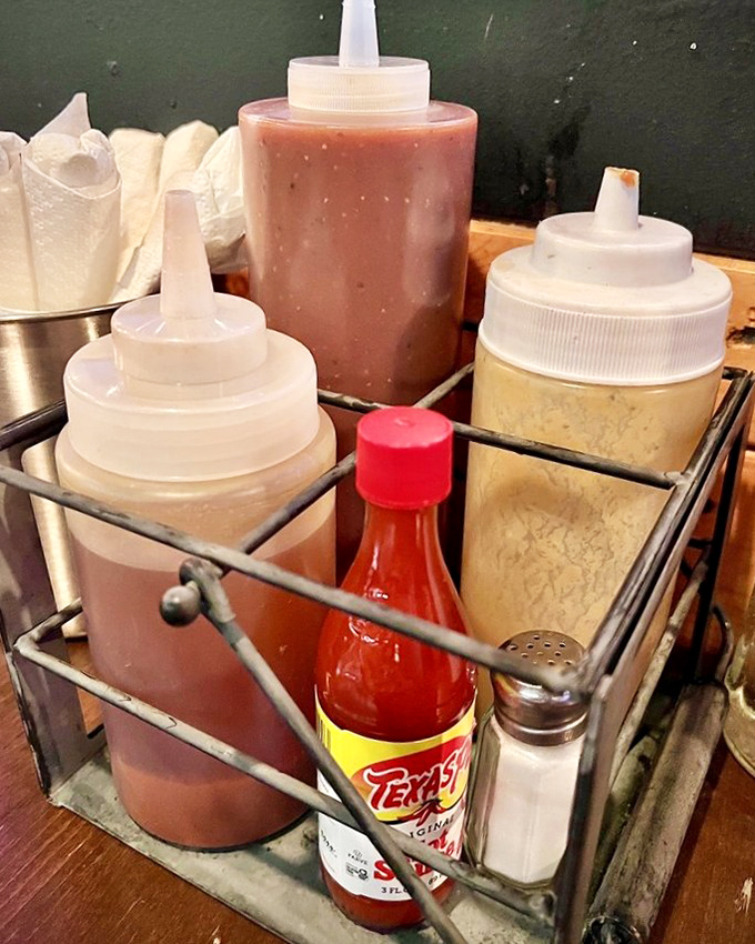 The sauce caddy&mdash;where vinegar, tomato, and mustard-based options peacefully coexist, proving barbecue diplomacy is possible after all.