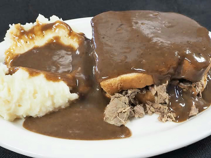 The hot roast beef sandwich &ndash; a masterpiece of tender meat, bread foundation, and gravy lava flow that makes mashed potatoes into edible islands.