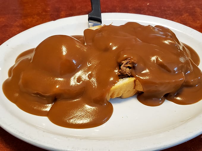 Hot roast beef drowning in rich brown gravy &ndash; the kind of open-faced sandwich that requires a fork, knife, and possibly a moment of silence.