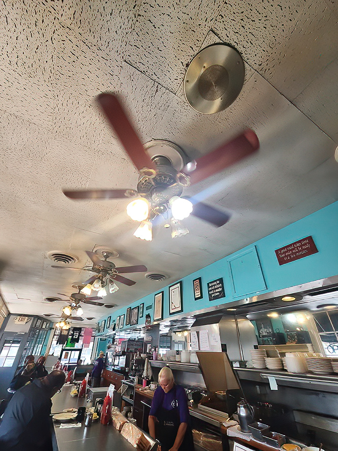 Ceiling fans spin stories overhead while the turquoise walls hold decades of Baltimore breakfast memories. Diners focus on what matters most&mdash;the plates before them.