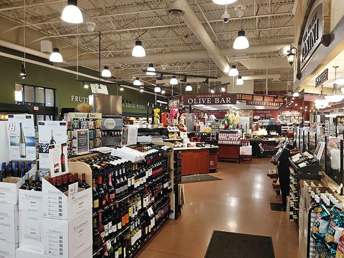 Wine bottles standing at attention like delicious soldiers. The olive bar and imported cheese section lurk in the background, plotting delicious conspiracies.