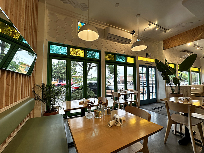 Sunlight streams through green-framed windows, turning an ordinary breakfast into the kind of moment that makes you glad you left your house.