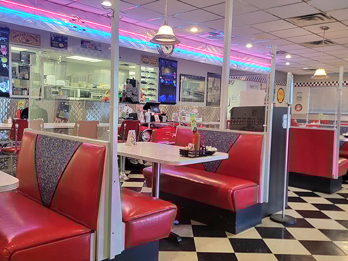 Red vinyl booths invite you to slide in and stay awhile, while neon lights cast that perfect retro glow that makes everyone look like they belong in a Norman Rockwell painting.