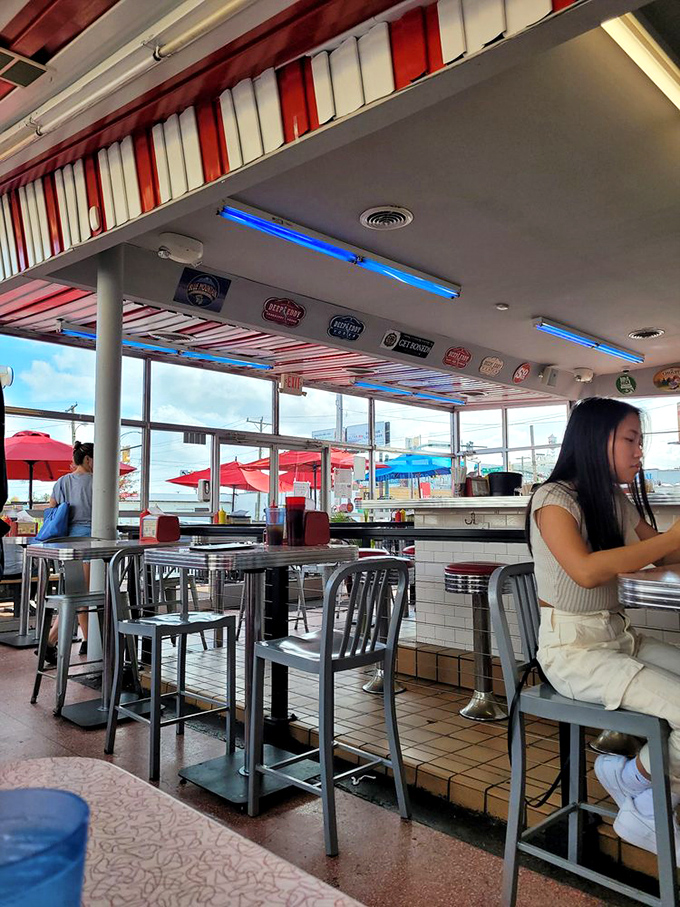 The counter seating offers prime real estate for burger enthusiasts who appreciate the theater of short-order cooking.